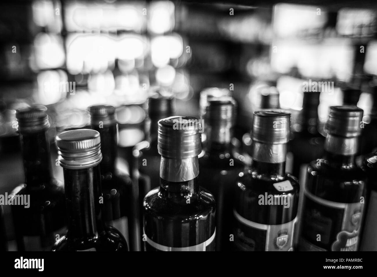 Fancy olive oil bottles with blurry product displays in the background ...