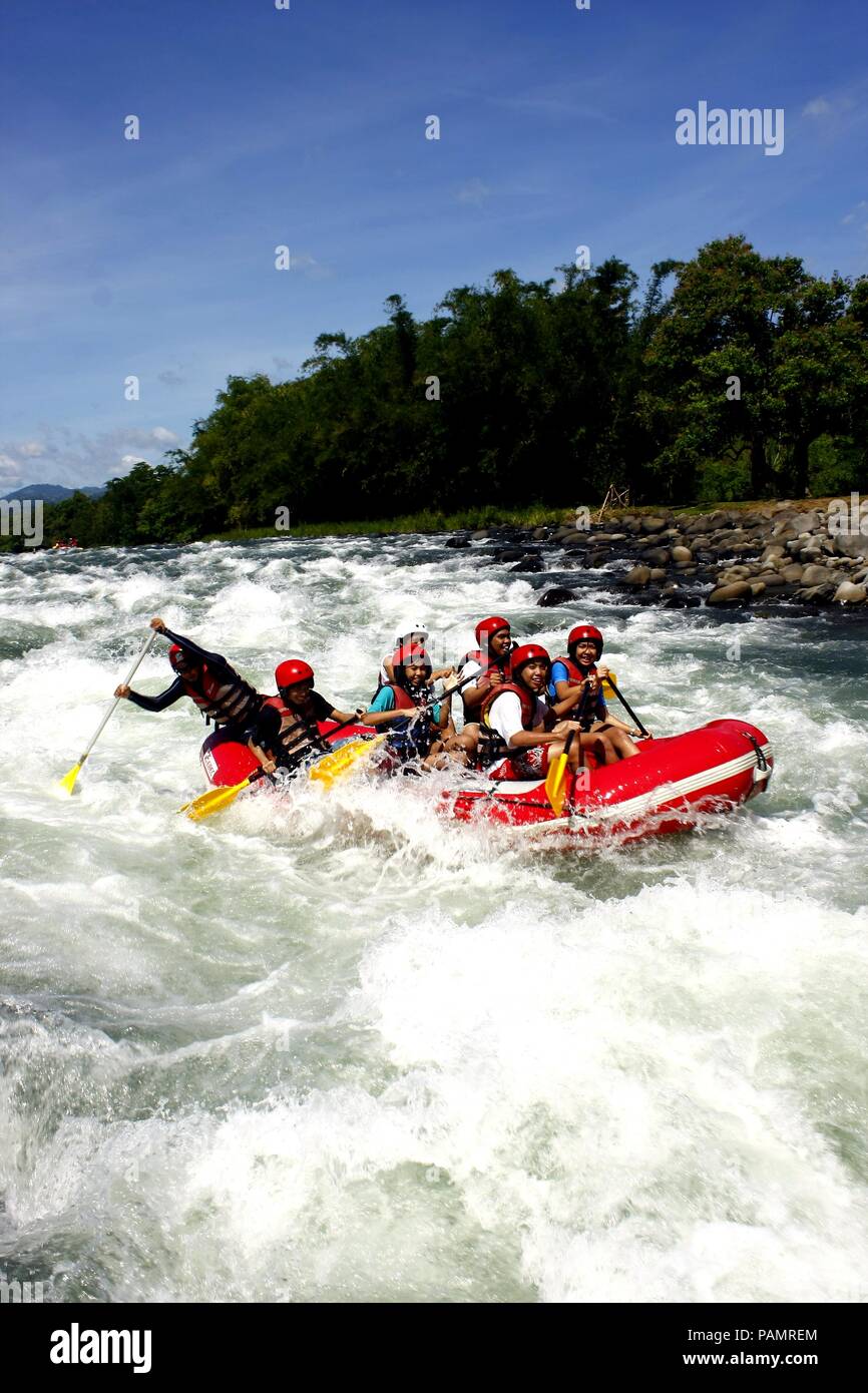 CAGAYAN DE ORO, MINDANAO, PHILIPPINES - JUNE 5, 2009: Tourists ride on ...