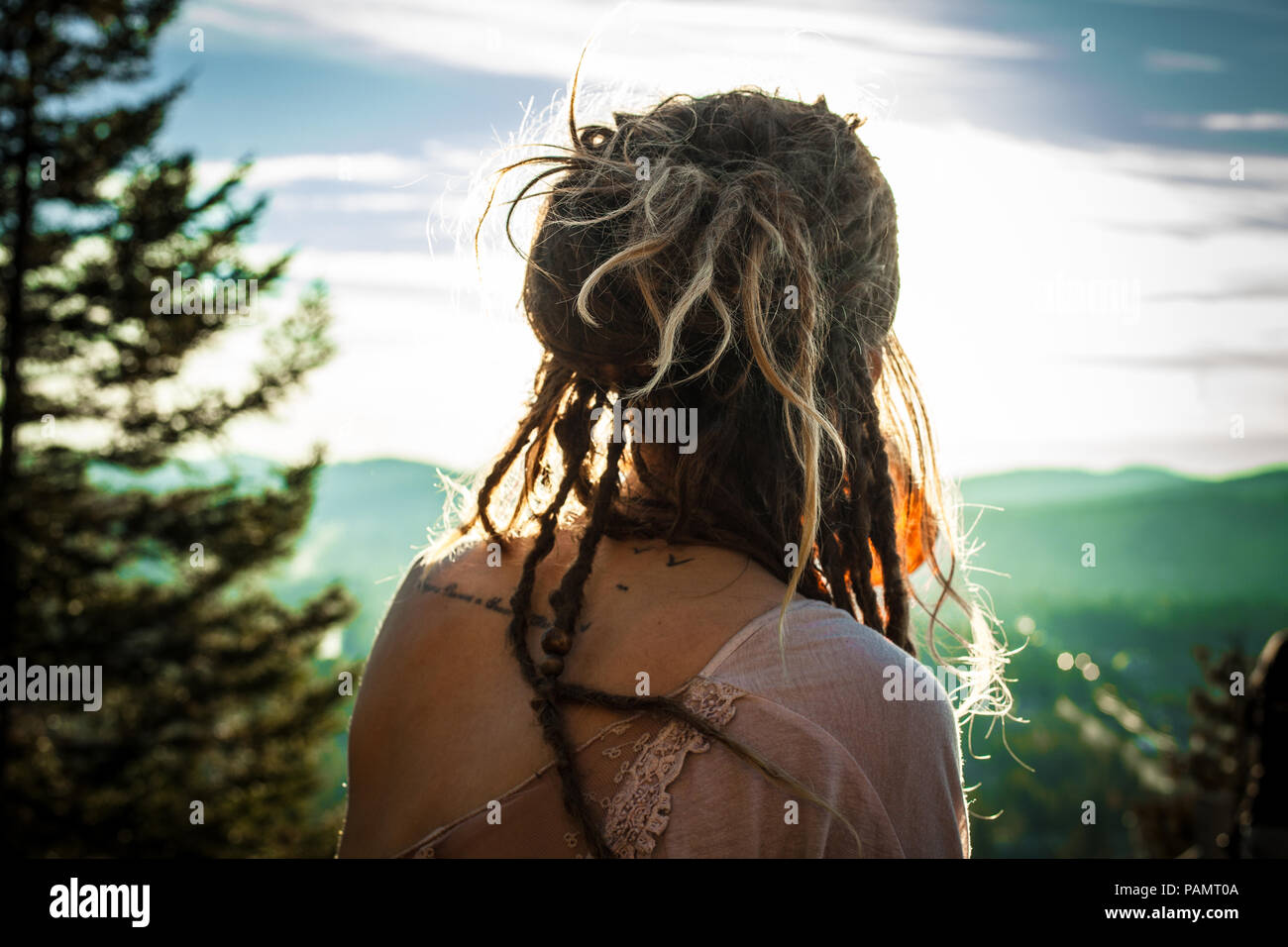 Girl on the top of a mountain with the sun Stock Photo - Alamy