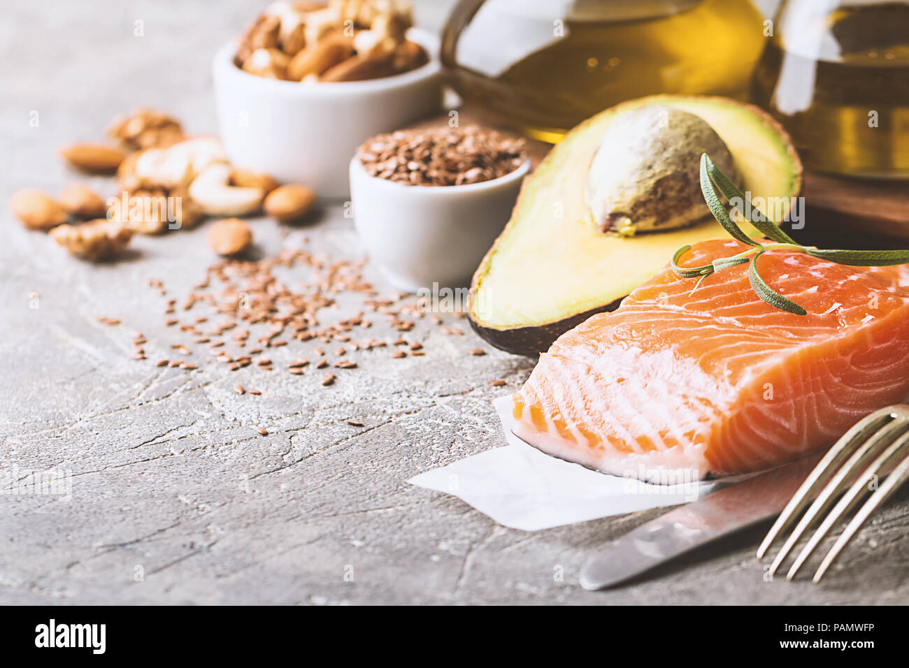 Healthy fats in nutrition - salmon, avocado, oil, nuts. Concept of ...