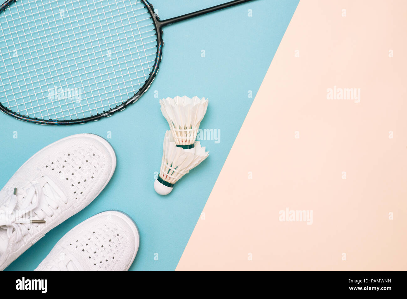 Shuttlecock and badminton racket with sport shoes on pastel color ...