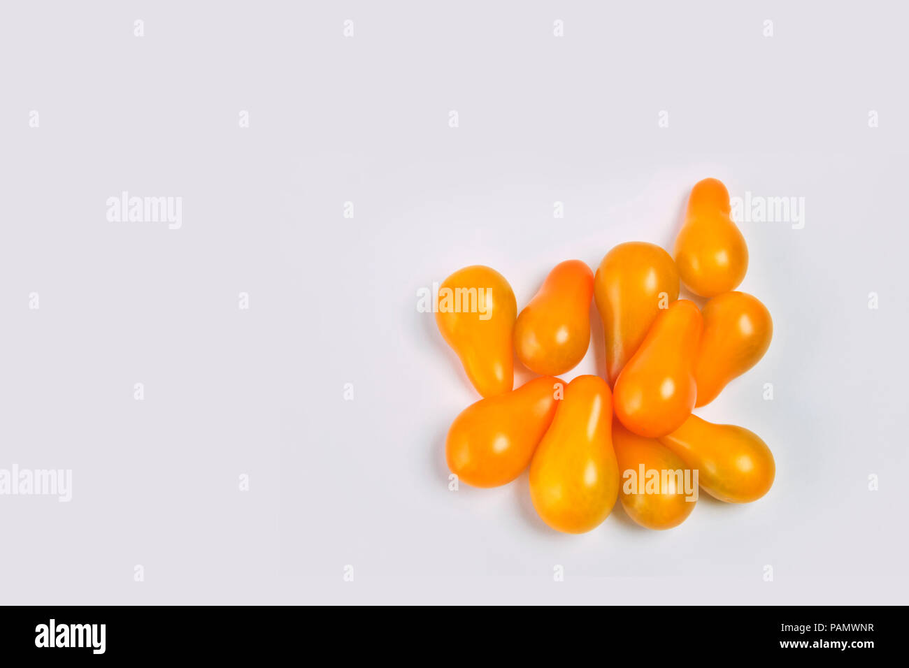 A pile of pear drop tomatoes ,bright light , studio shot , horizontal ...