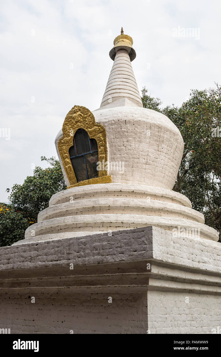 Large white-washed stupa and bodhi tree in the first courtyard of ...
