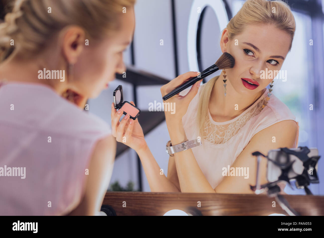 Makeup artist holding rose powder blusher in her hand Stock Photo - Alamy