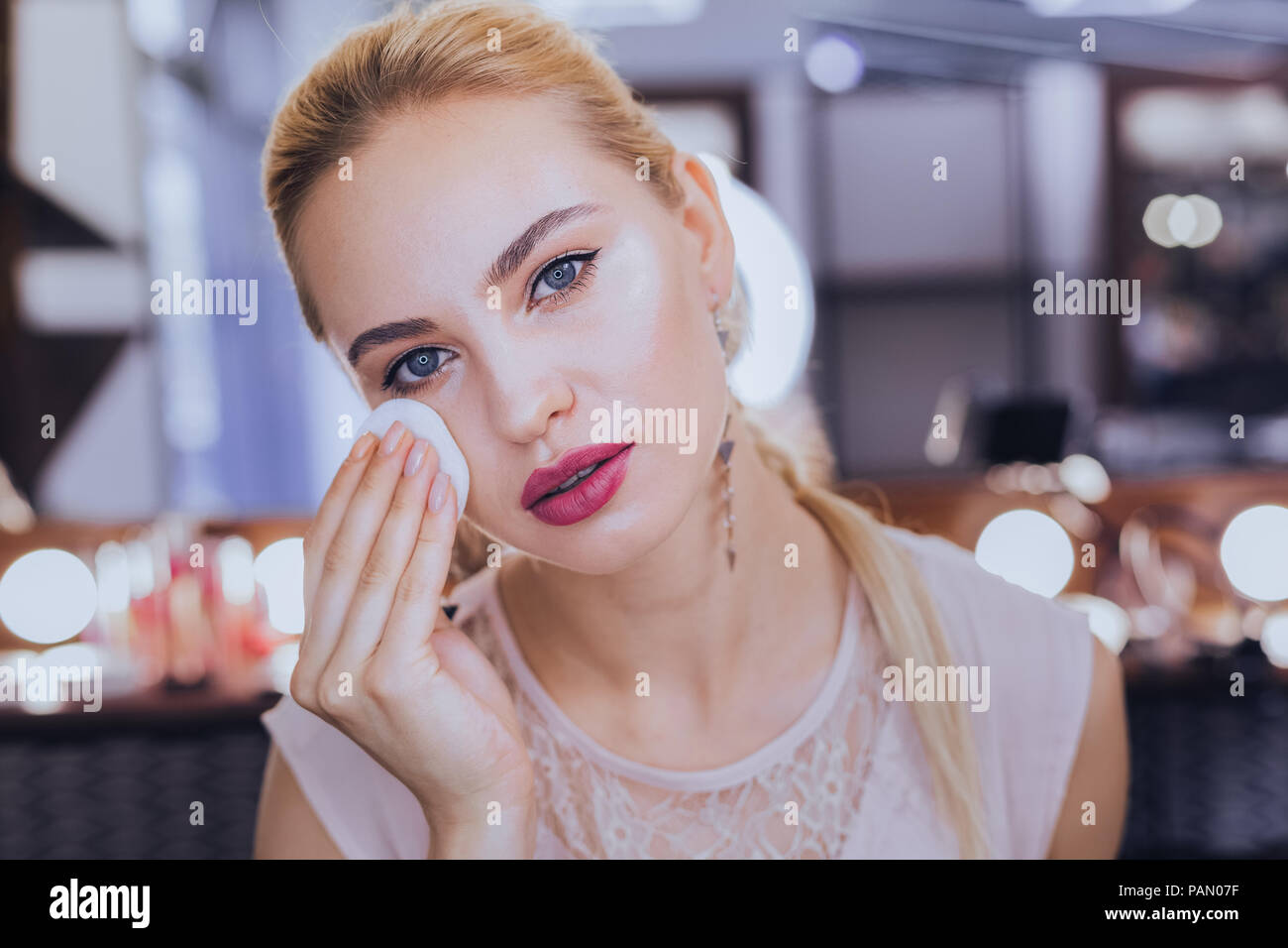 Woman taking off eye makeup hi-res stock photography and images - Alamy