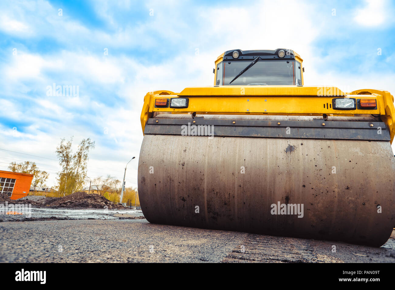Road construction works with roller compactor machine and asphalt ...