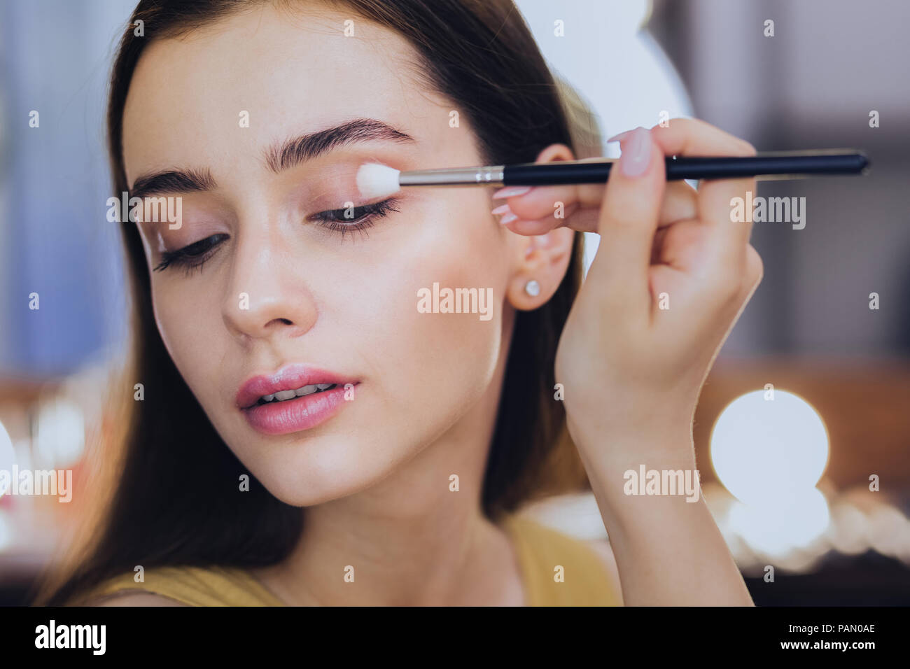 Gorgeous good-looking woman using her eye shadows Stock Photo - Alamy