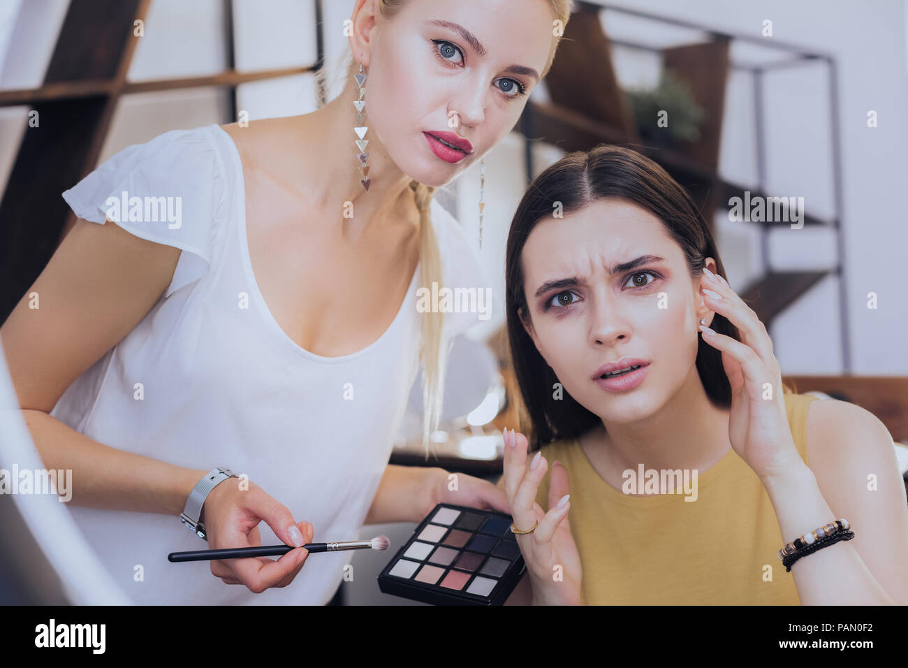 Dark-haired woman feeling angry while seeing result of her makeup Stock ...