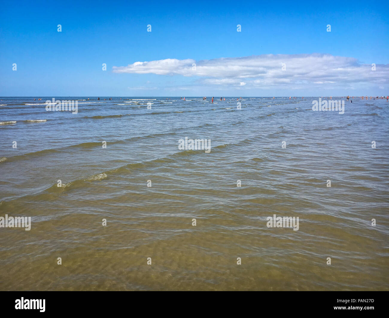 People enjoying shallow water of North Sea at St. Peter-Ording beach at ...