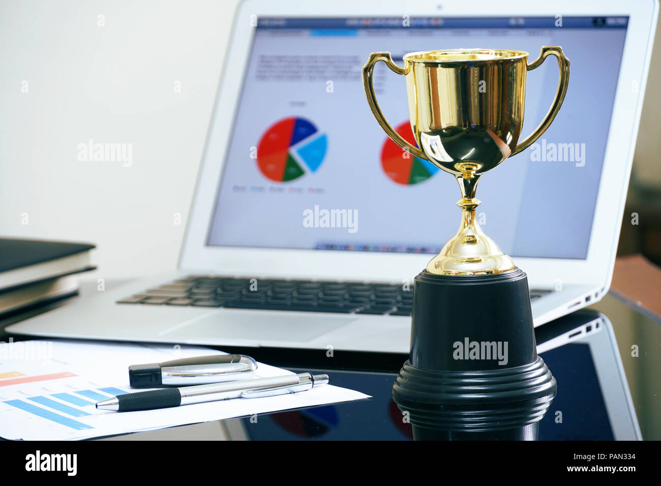 Winner hold trophy on working table, achive business concept Stock ...