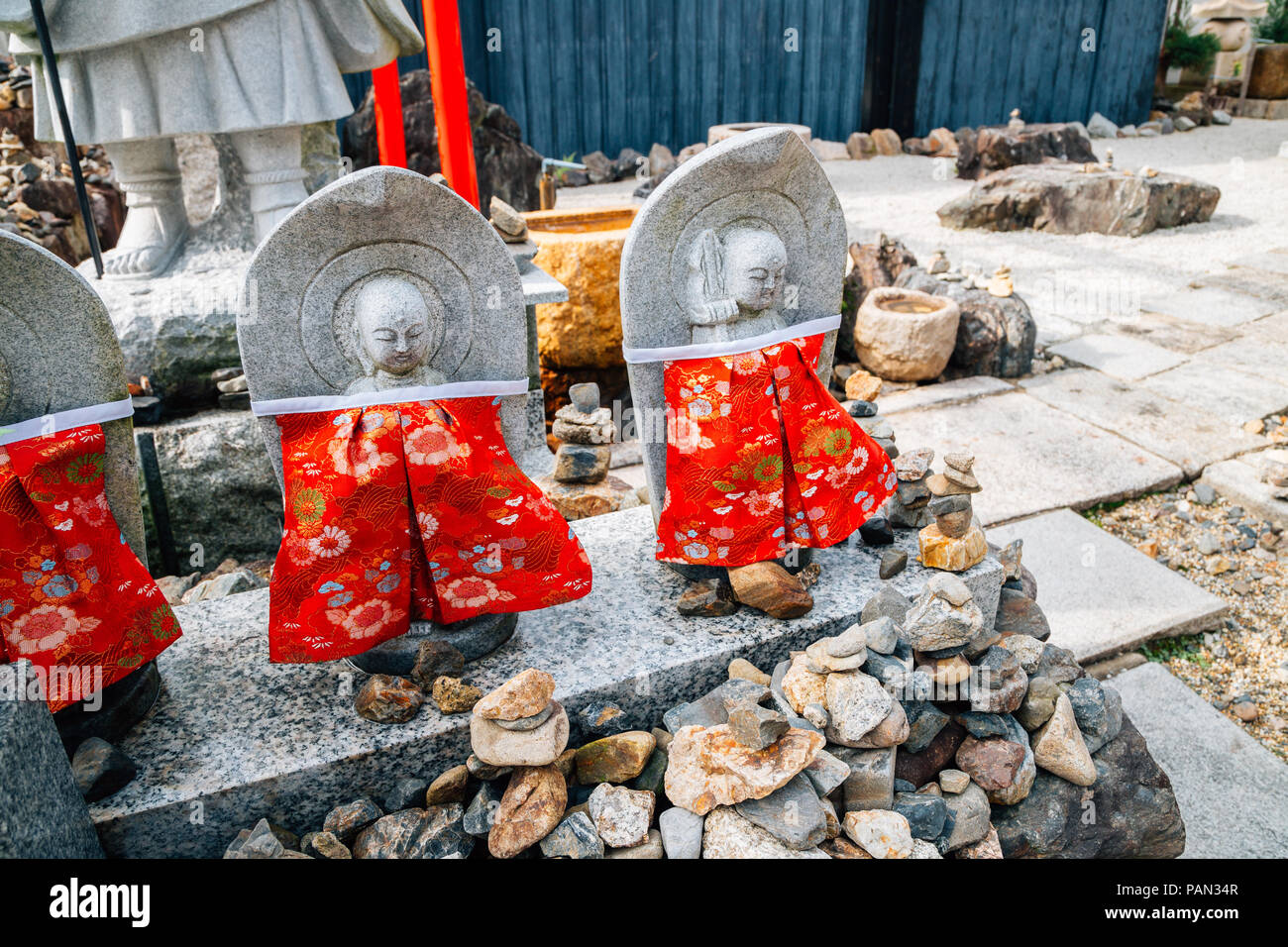 Buddha stone statue wearing red apron in Kyoto, Japan Stock Photo - Alamy
