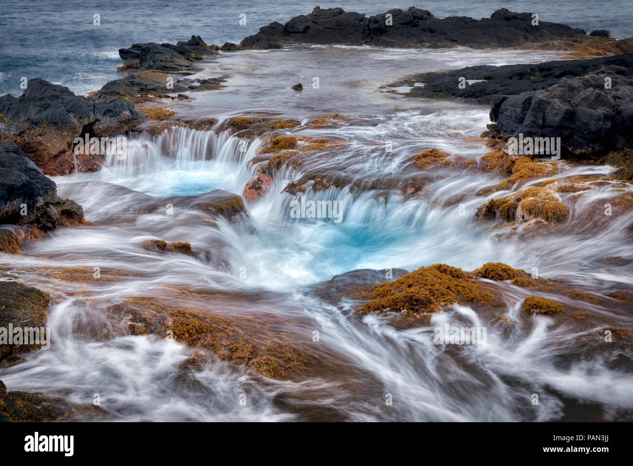 Ocean water drain well and sunset. Hawaii Island. The Big Island Stock ...