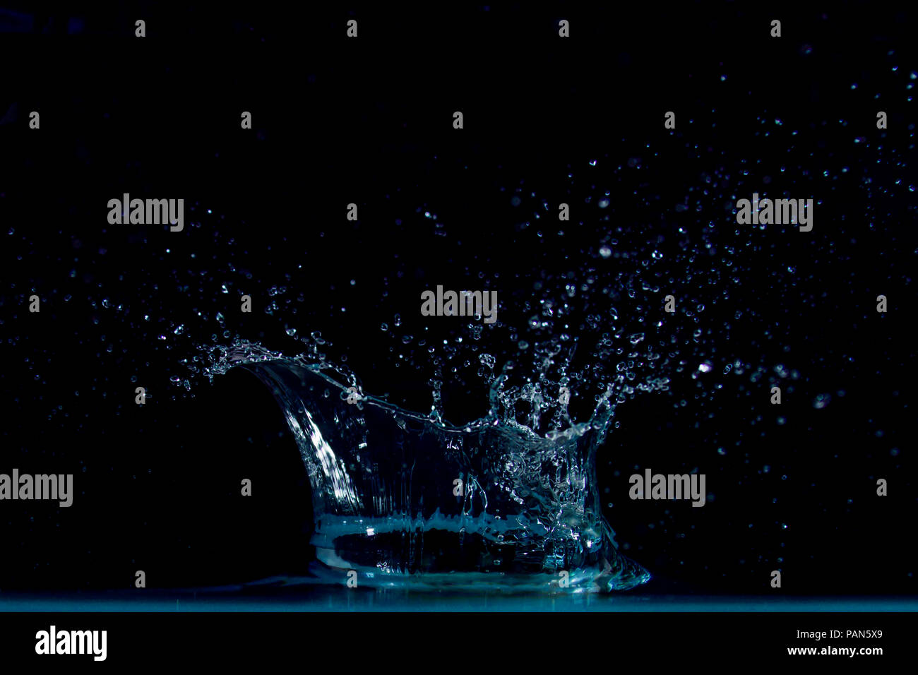 Blue water splash black background hi-res stock photography and images ...