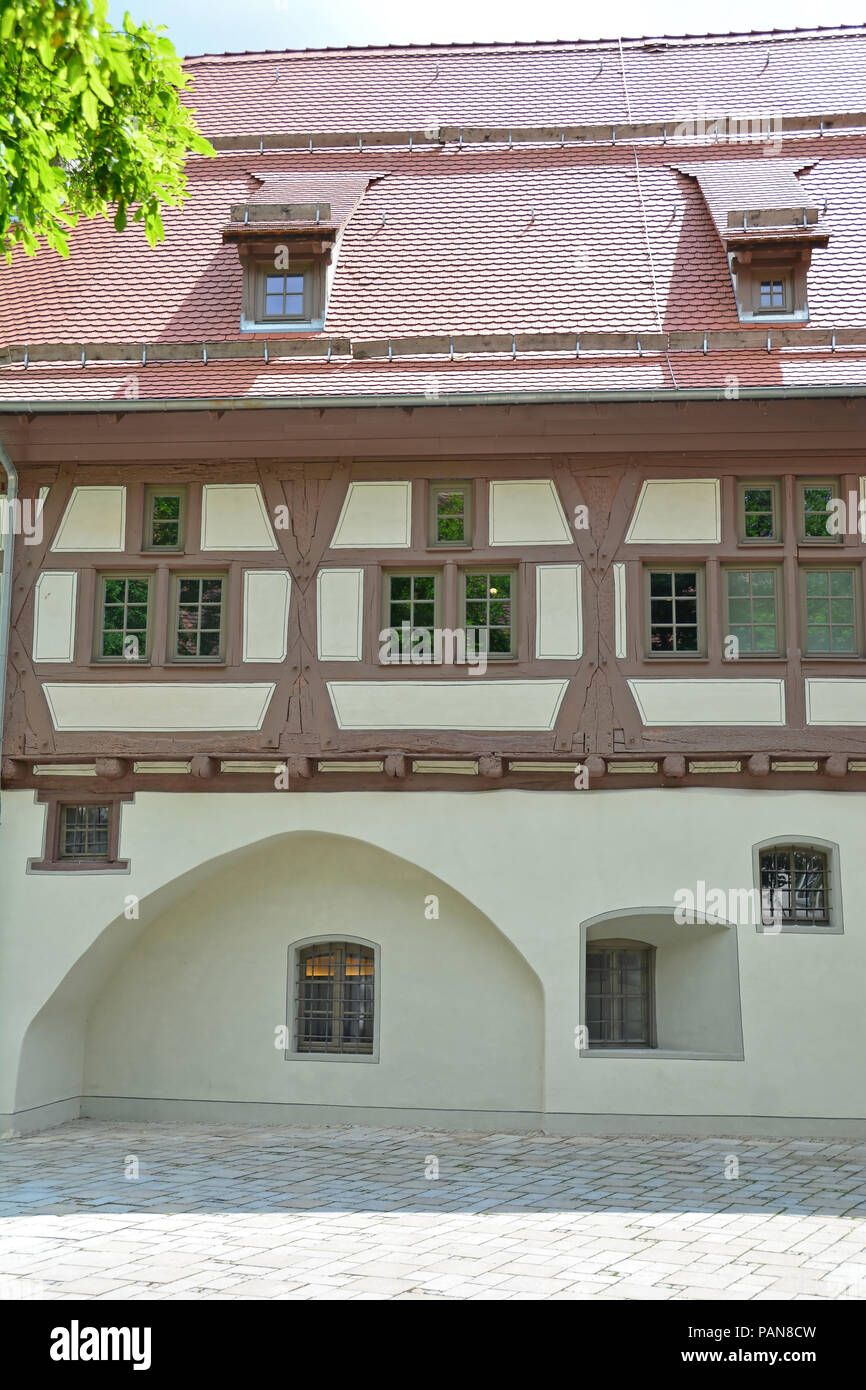 German half timbered building in medieval town with flag stone streets ...