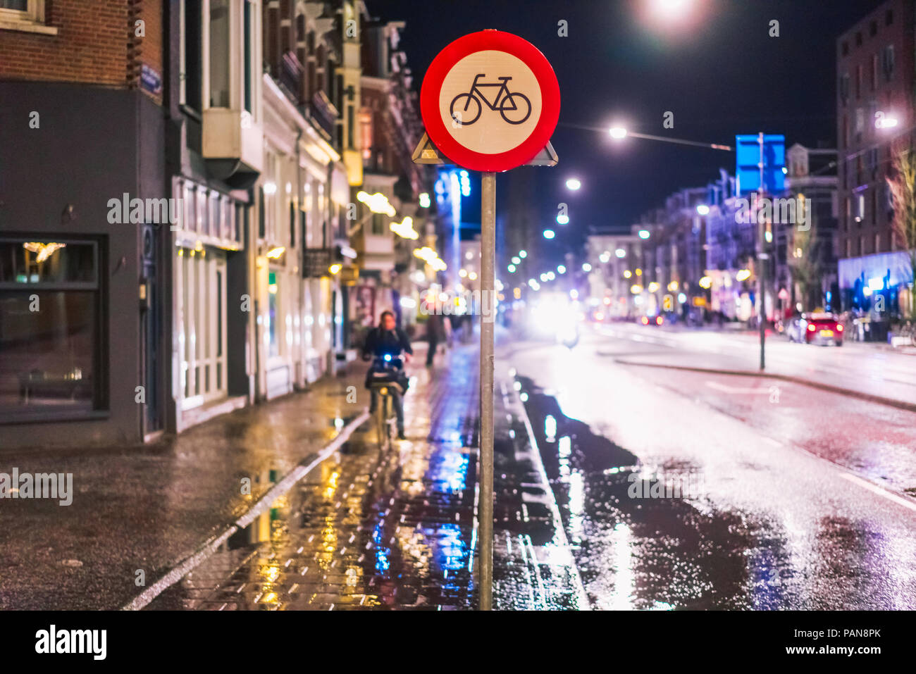 Bicycle lane sign on a night street Stock Photo - Alamy