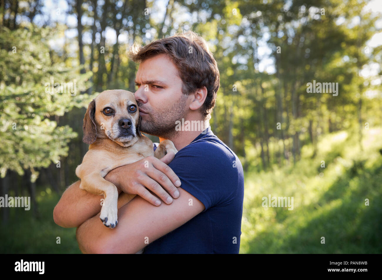 Man holding dog in his arms hi-res stock photography and images - Alamy