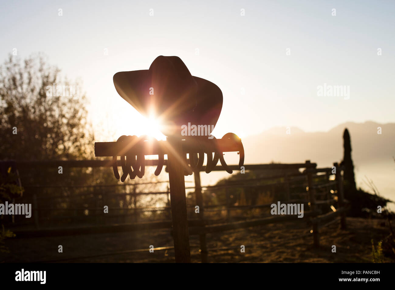 Cowboy hat in the sunset on a farm Stock Photo - Alamy