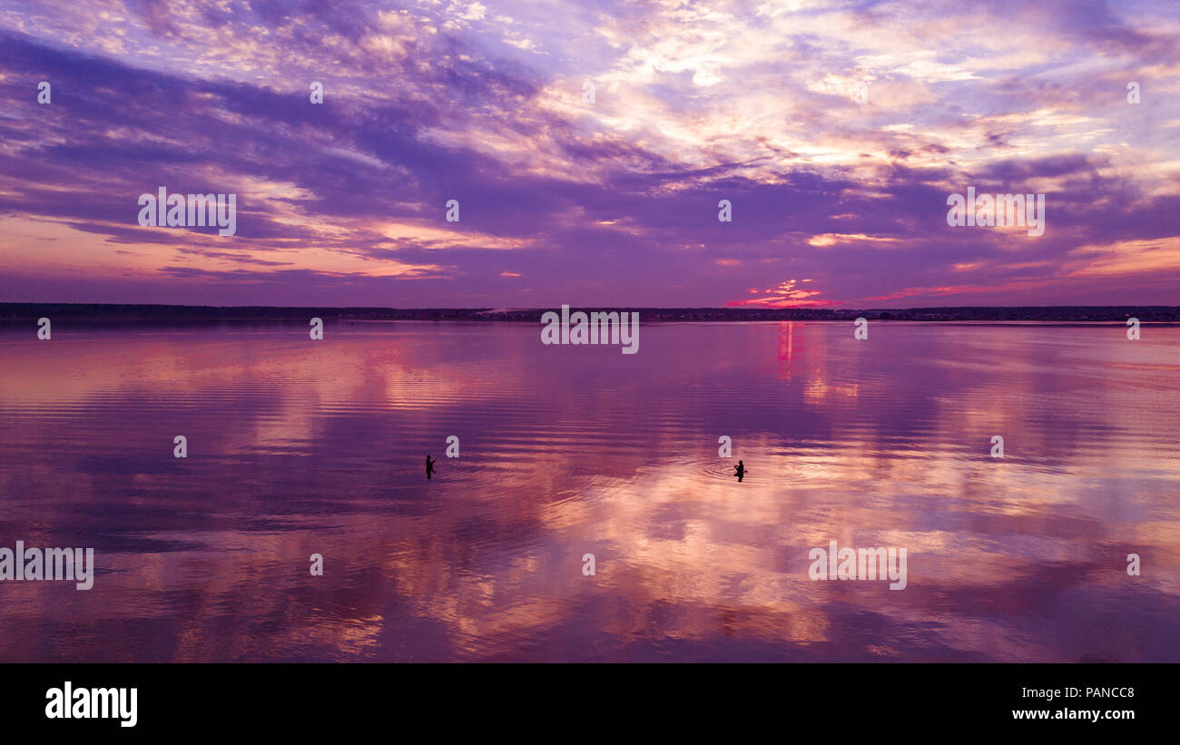 Aerial drone panoramic view of colourful purple sunset on the lake, sun ...