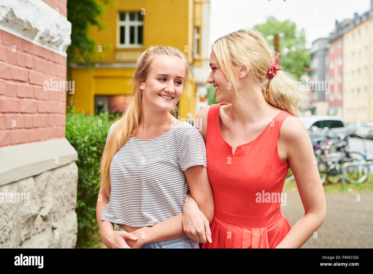 Women walk arm in arm hi-res stock photography and images - Alamy