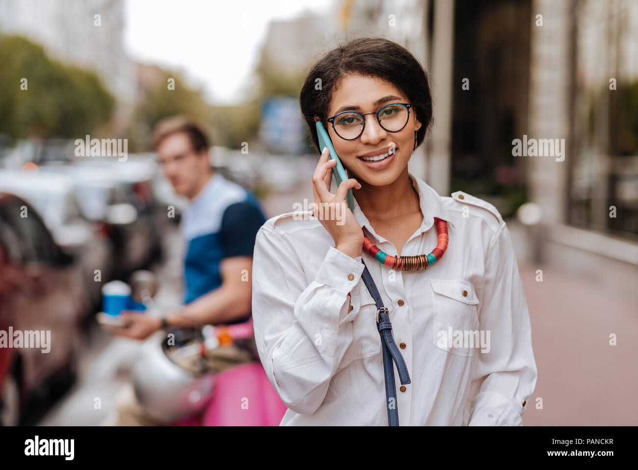Charming female colleagues calling Stock Photo - Alamy
