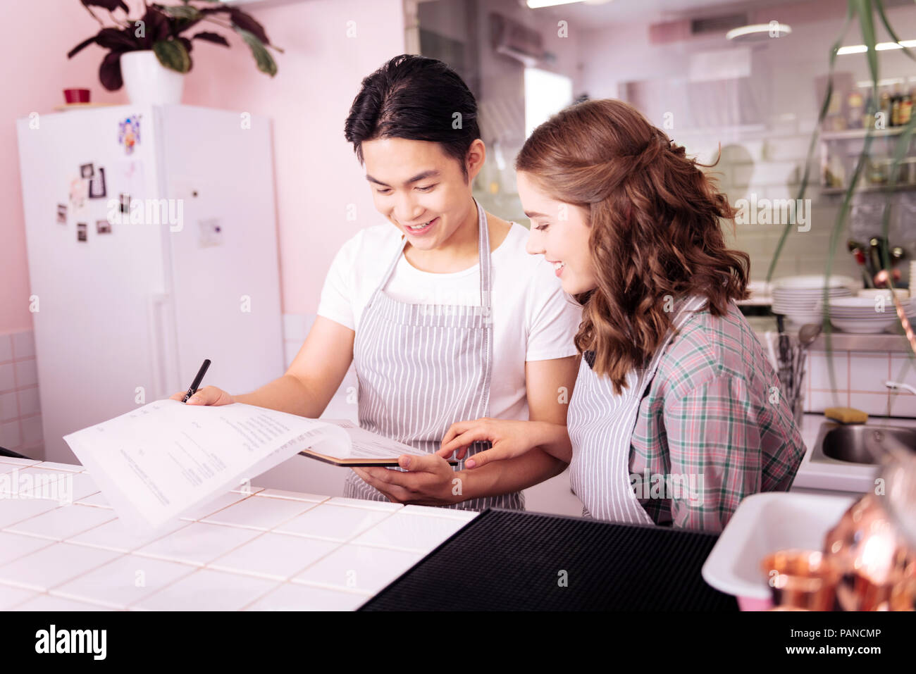 Two promising entrepreneurs creating menu for their little cafe Stock ...