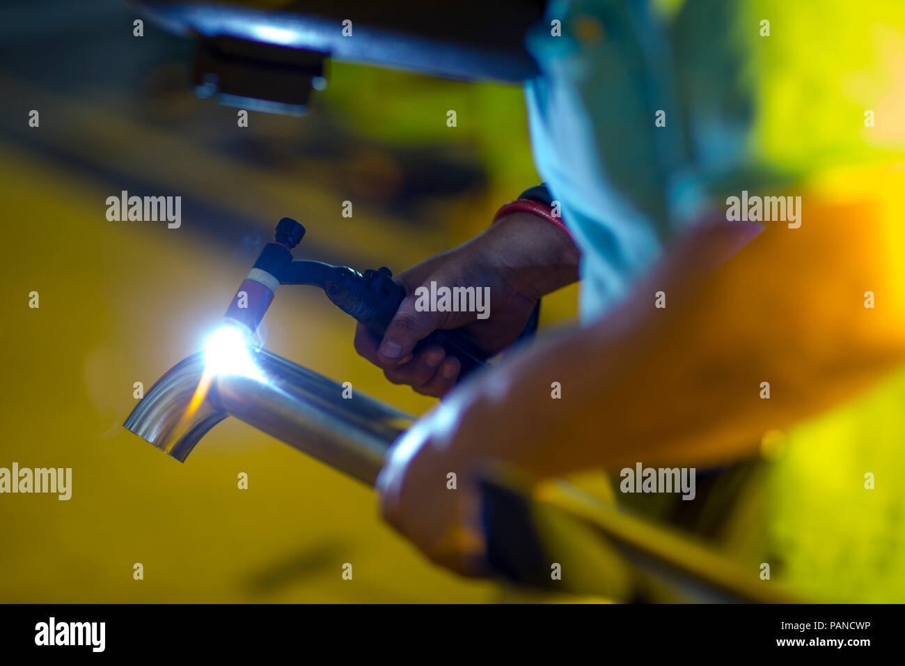 Welder in industrial plant welding tanks Stock Photo - Alamy