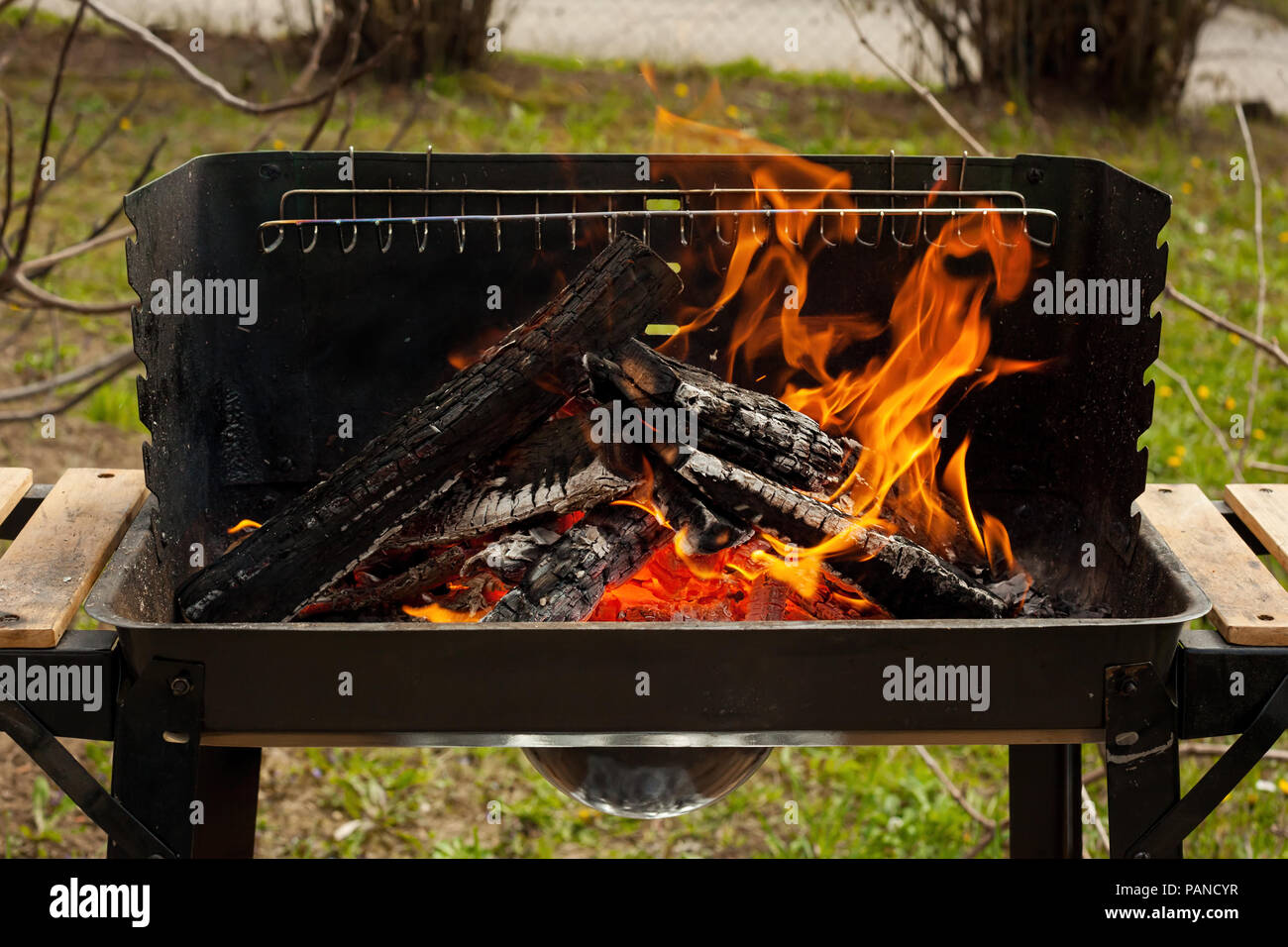 Barbecue grill with fire on nature, outdoor, close up Stock Photo - Alamy