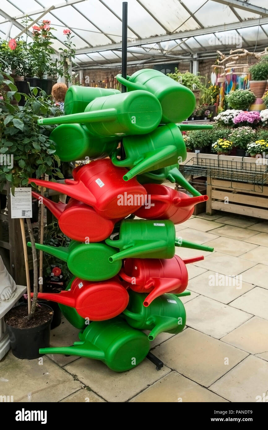 An unusual display of plastic colourful watering can on sale in a ...