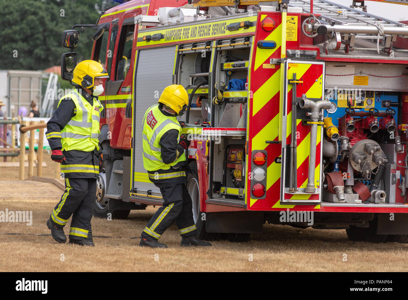 Fire service personnel demonstrating emergency procedures with a fire ...