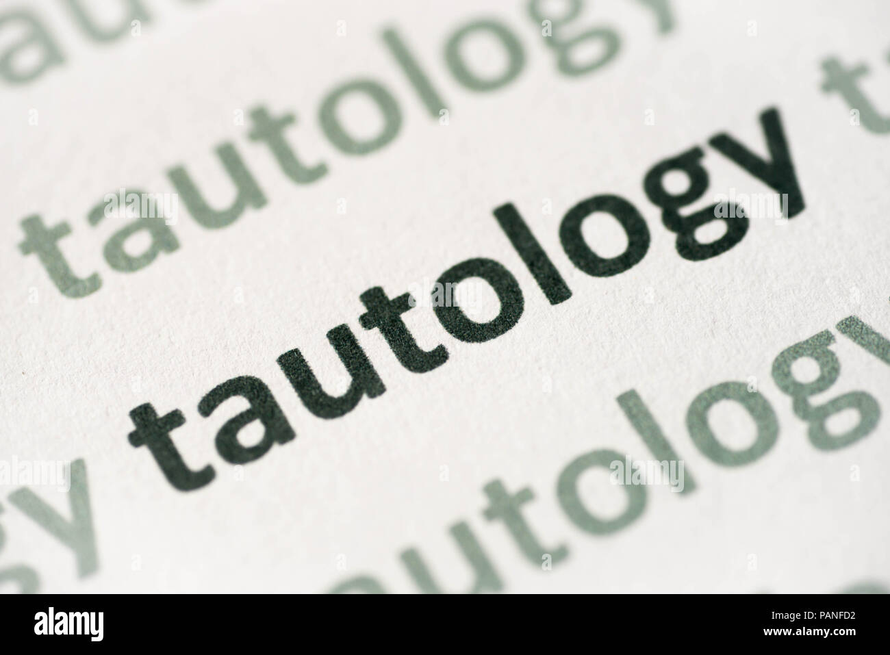 word tautology printed on white paper macro Stock Photo - Alamy
