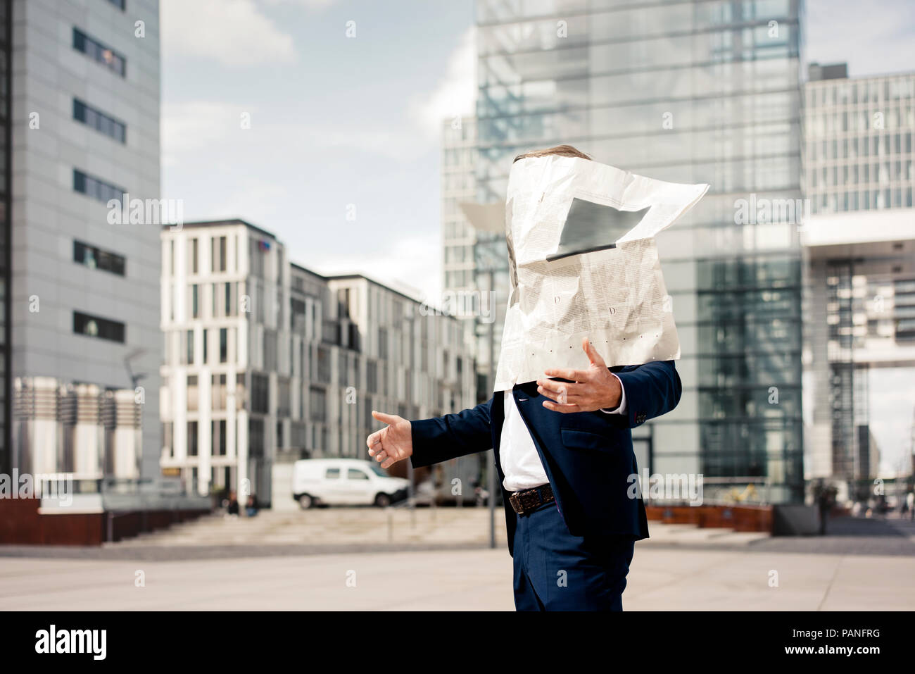 Newspaper covering businessman's face in the city Stock Photo - Alamy