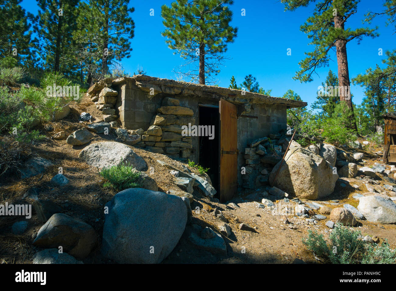 Old stone and wood structure in the forest along Highway 108 ...
