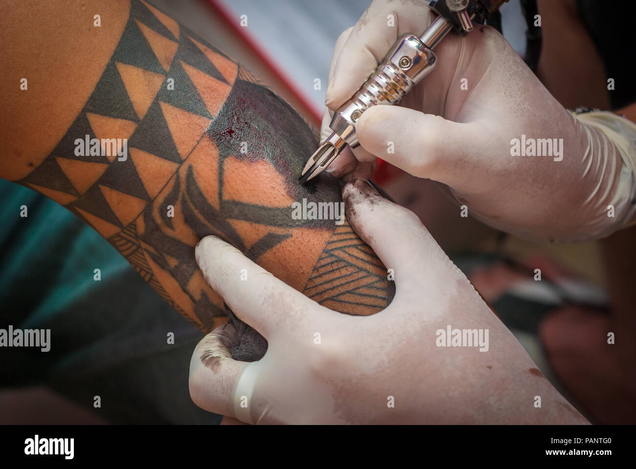 Unknown man having his tattoo made by a tattoo artist Stock Photo - Alamy