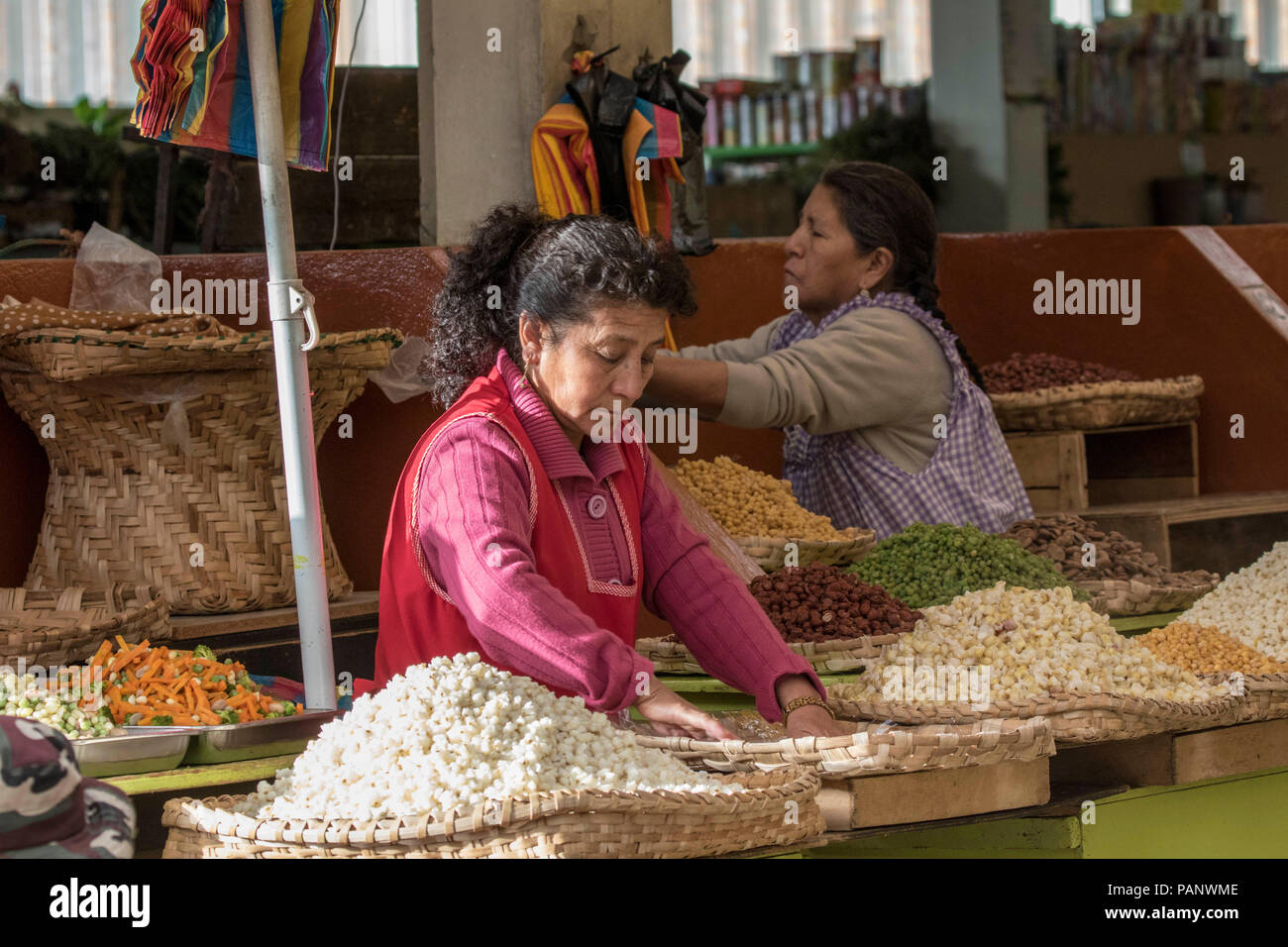 Women tending to produce in a farmers market in Cuenca Ecuador Stock ...