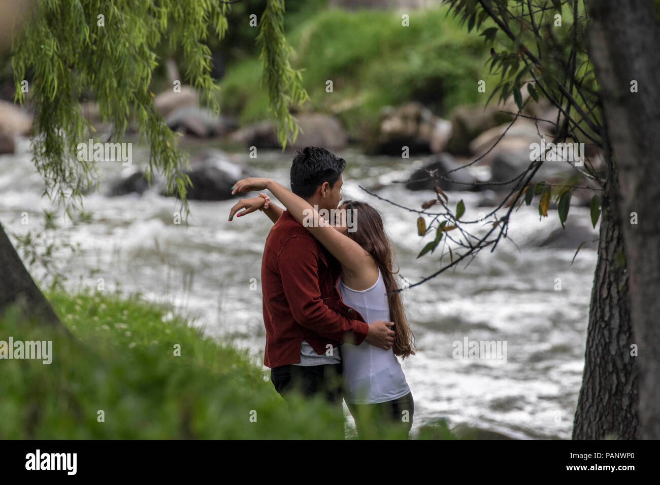Young couple embracing in a park in Cuenca, Ecuador Stock Photo - Alamy