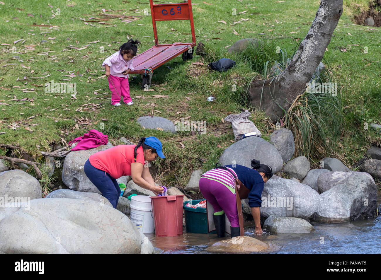 Latin American women doing their laundry in the local city park river ...
