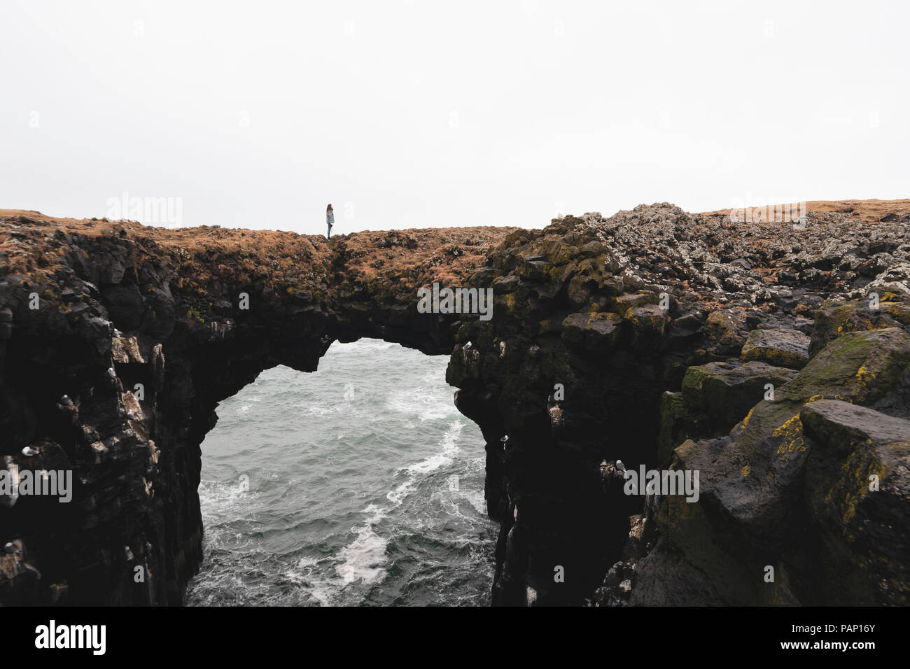 Woman standing rock arch hi-res stock photography and images - Alamy