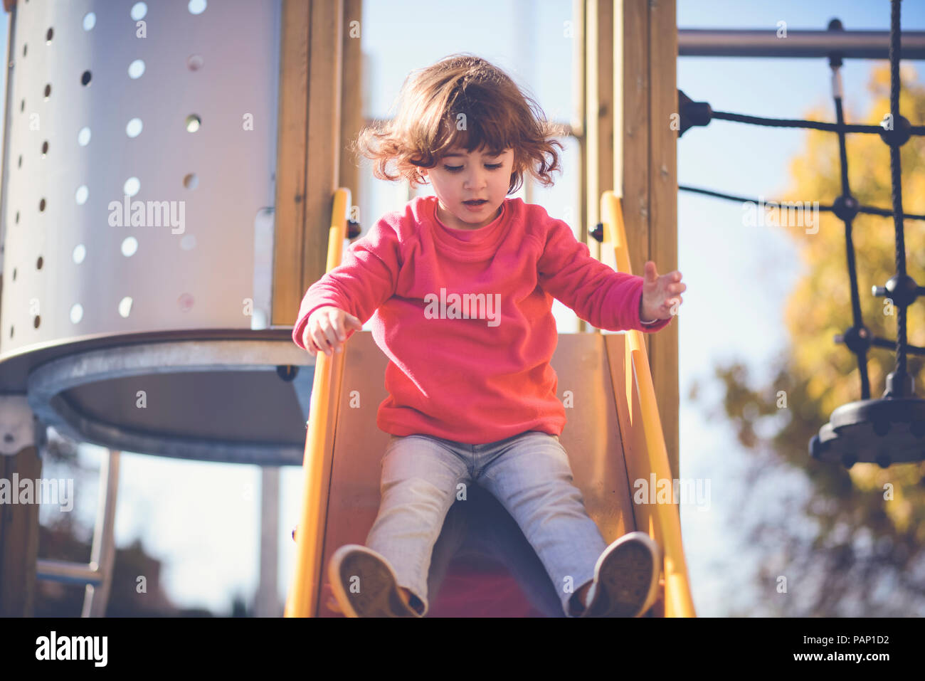 Happy Little Girl Sliding Fotolia