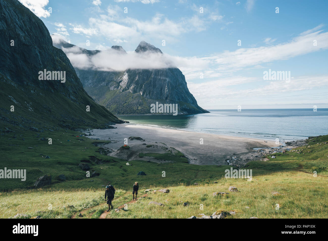 Norway, Lofoten, Moskenesoy, Young men hiking at Kvalvika Beach Stock ...