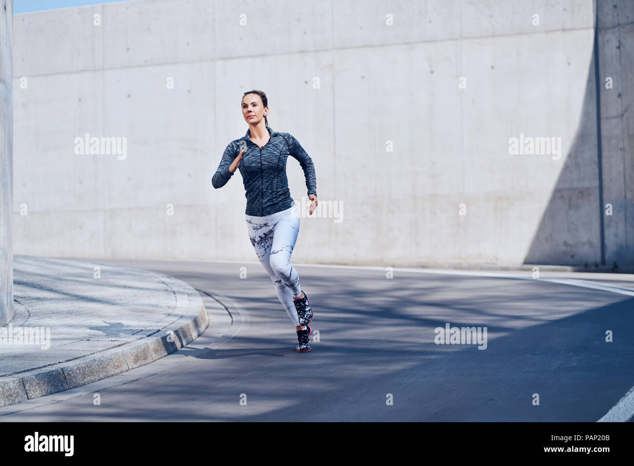 Female jogger on street Stock Photo - Alamy