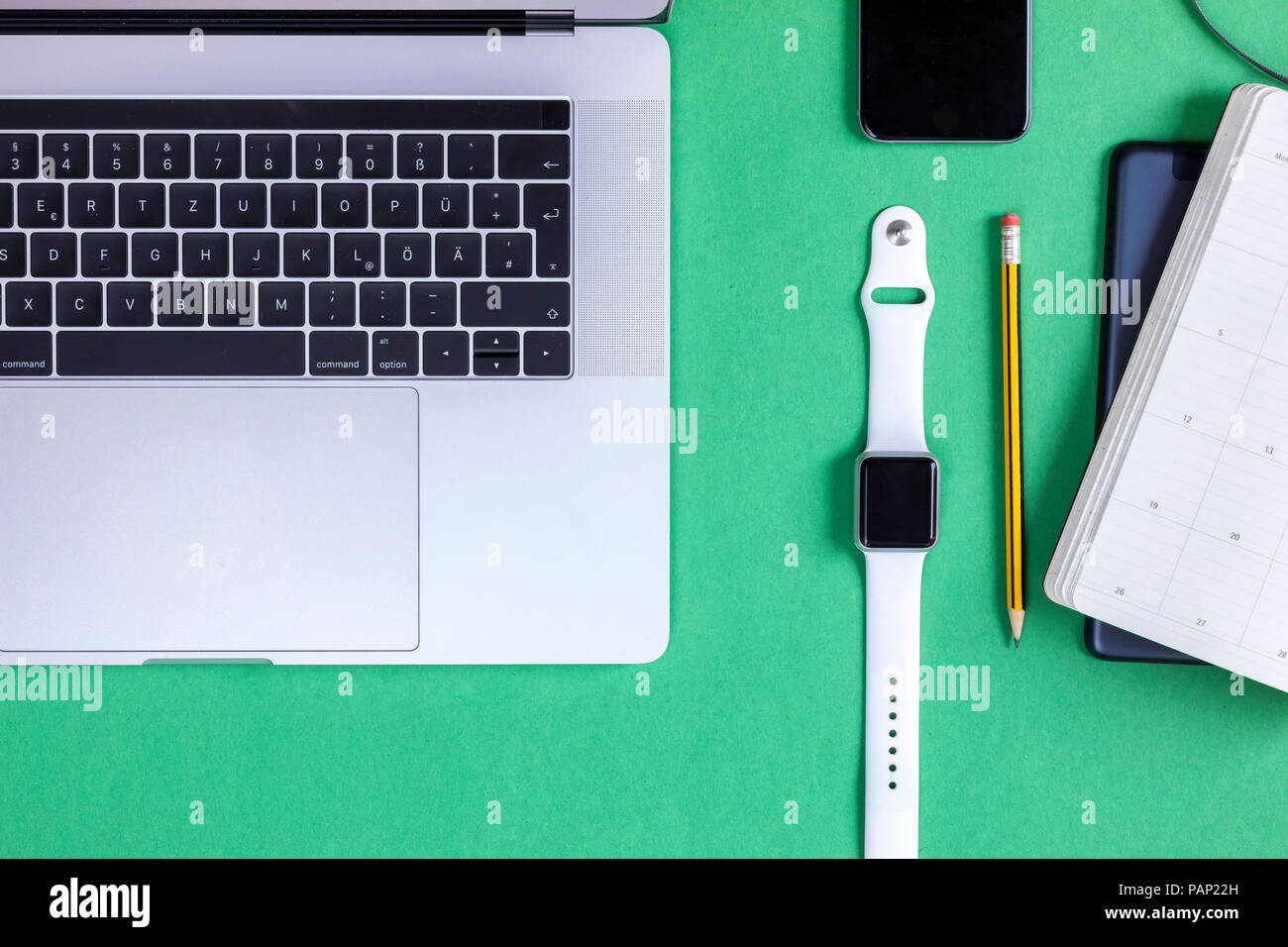 Business desk in front of green background seen from above Stock Photo ...