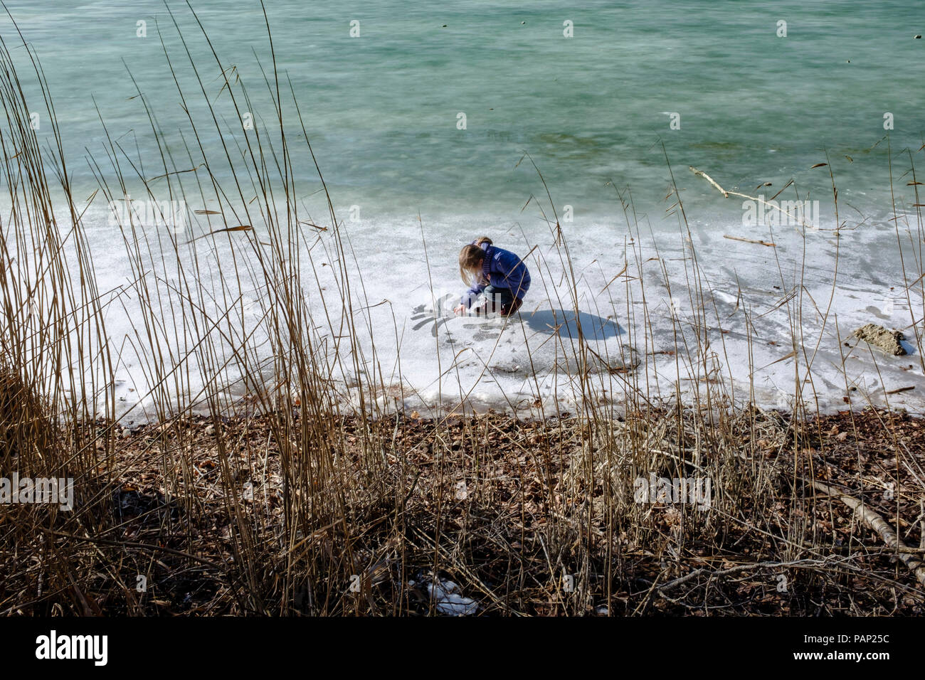 Girl playing on icy surface Stock Photo - Alamy