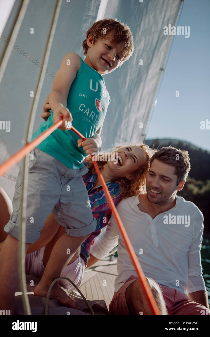 Happy family on a sailing boat Stock Photo - Alamy
