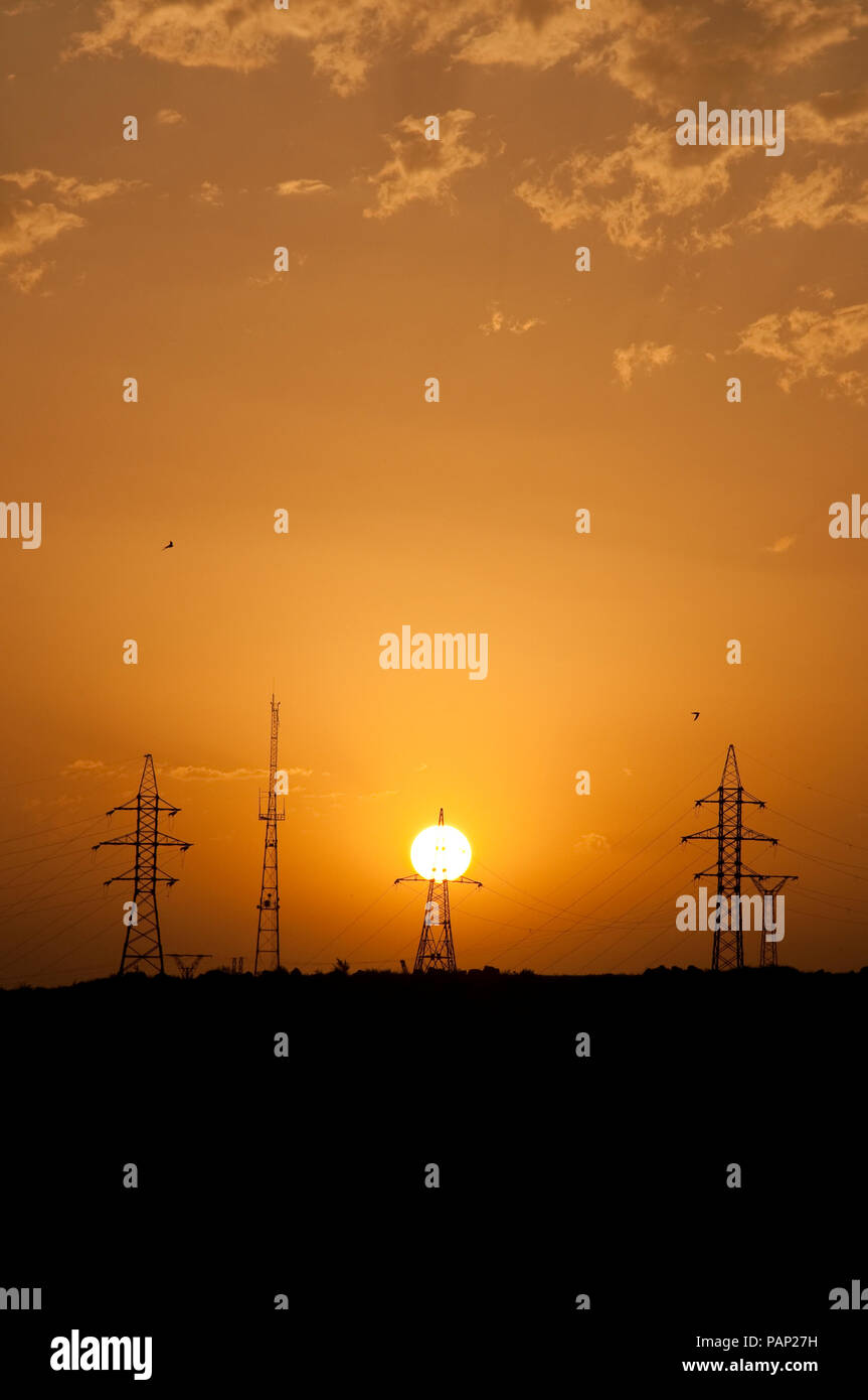 High Voltage Power Poles at Sunset. Looks Like They Are Being Charged ...