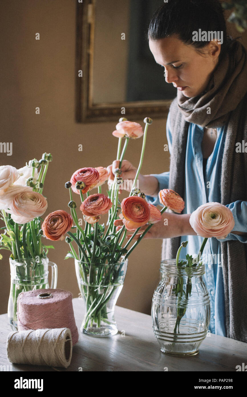 Woman arranging fresh flowers Stock Photo - Alamy