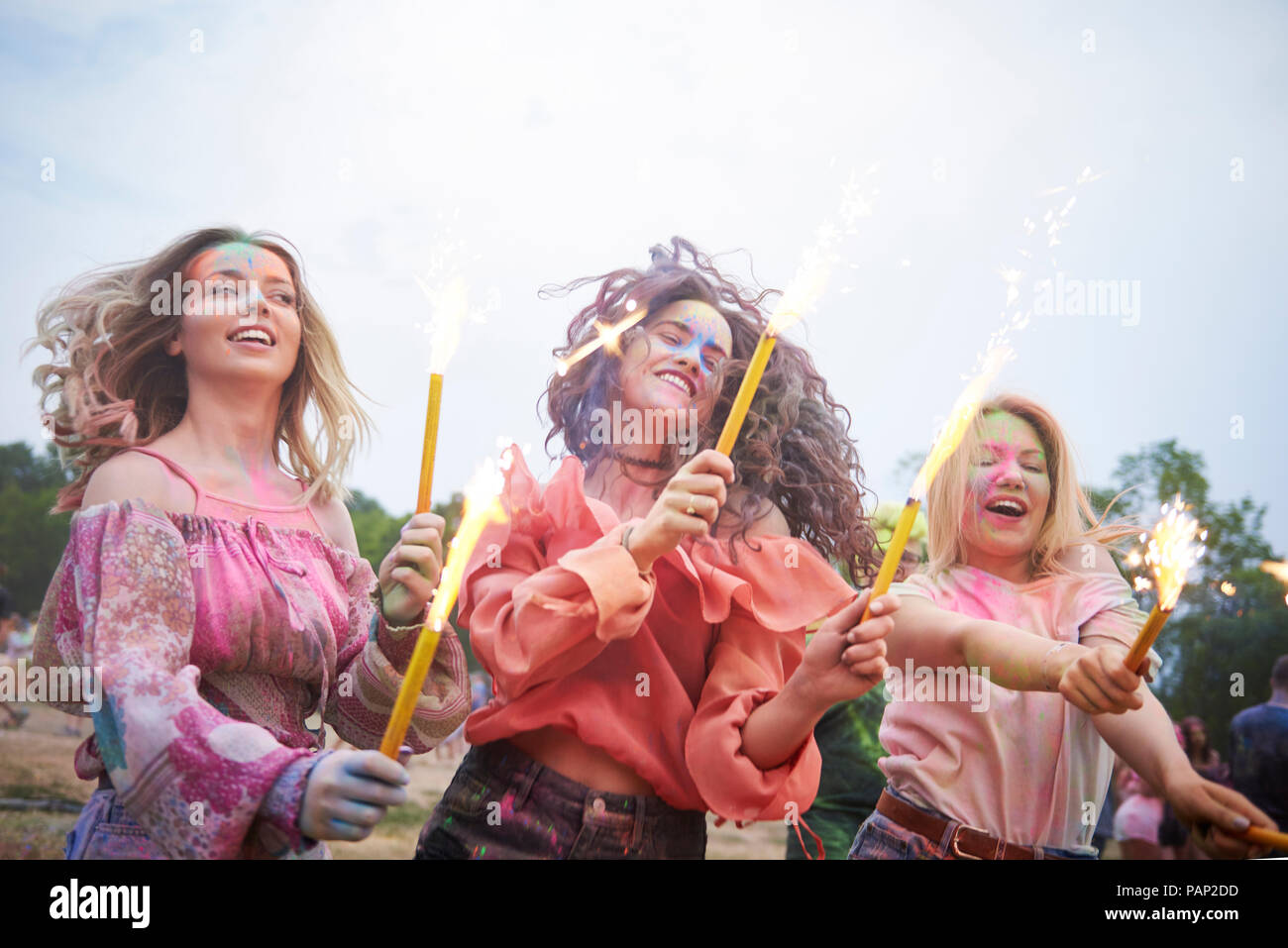 Friends with sparklers dancing at music festival Stock Photo - Alamy