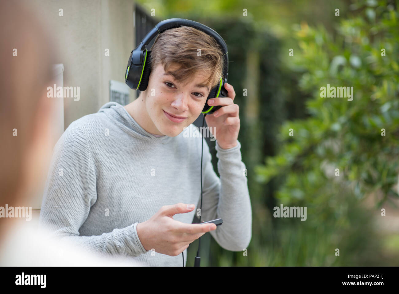 Boy listening to music from headphones Stock Photo - Alamy