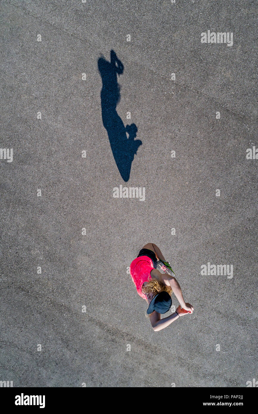 Aerial view of jumping young woman, shadow Stock Photo - Alamy