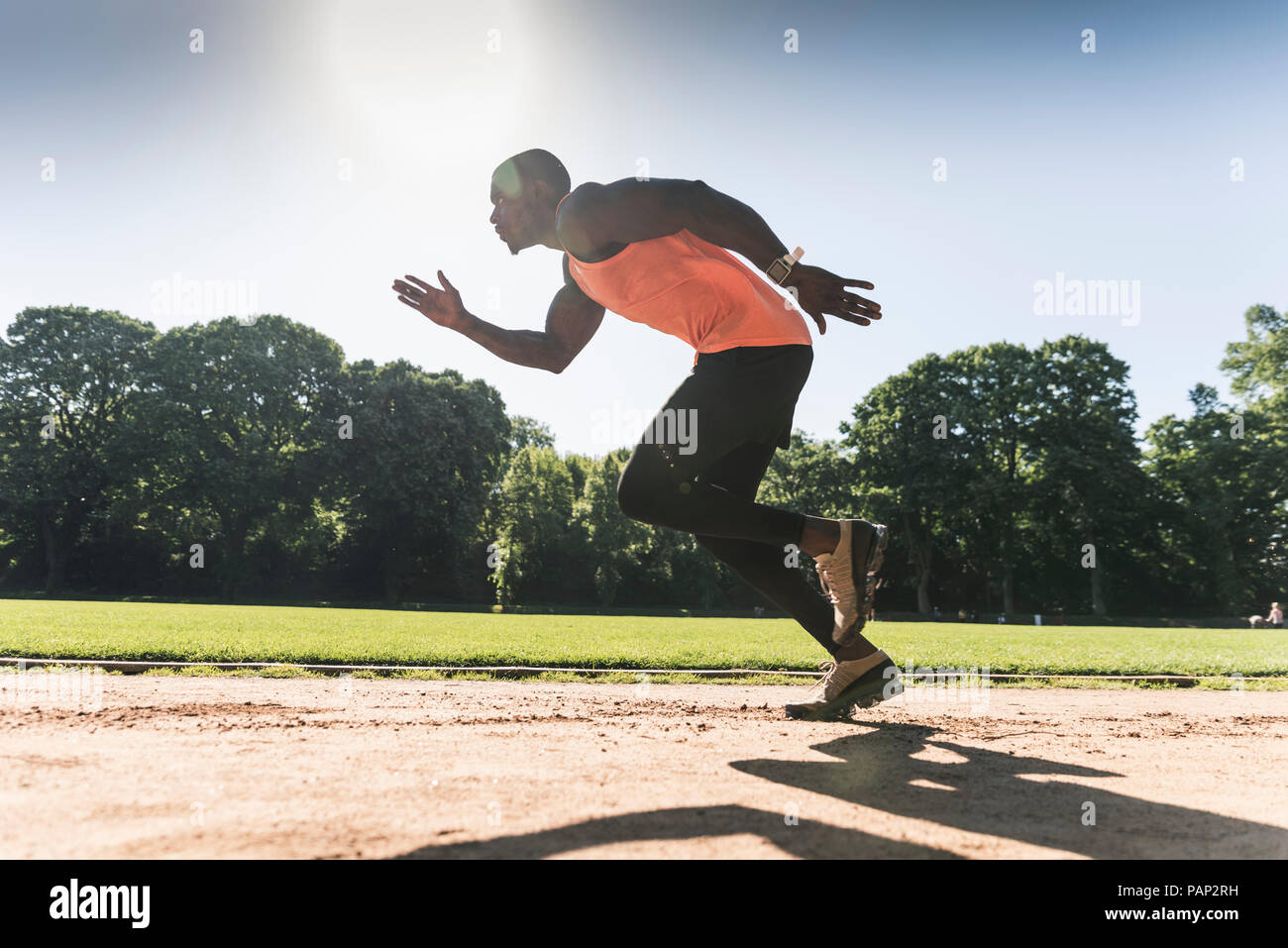 Young athlete on sports field training running Stock Photo - Alamy