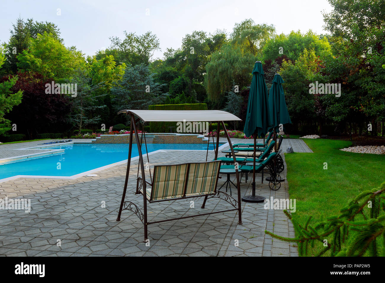clean swimming pool and empty resting chair Stock Photo - Alamy